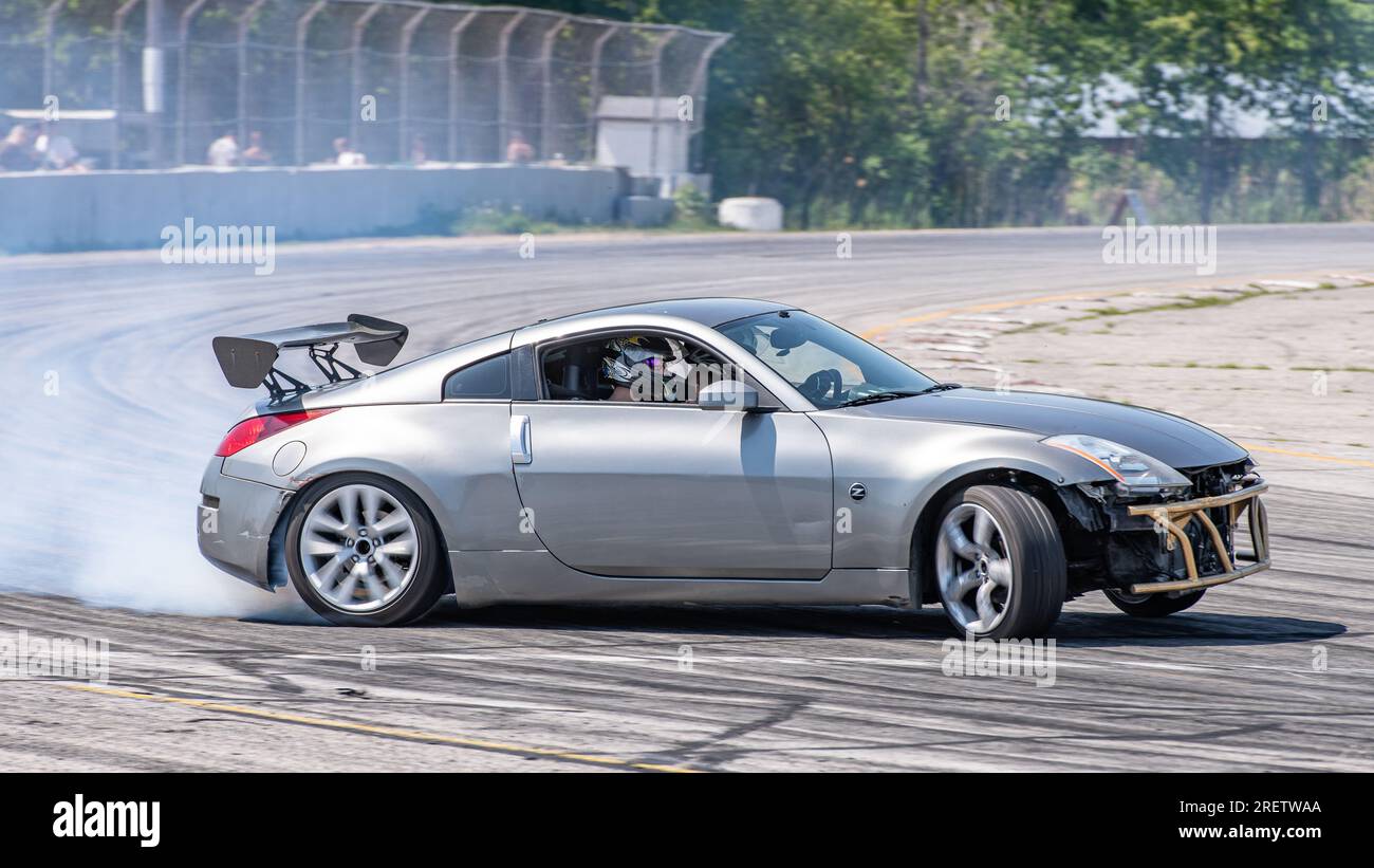 Car drifting auto racing event action with smoking tires - burning ...