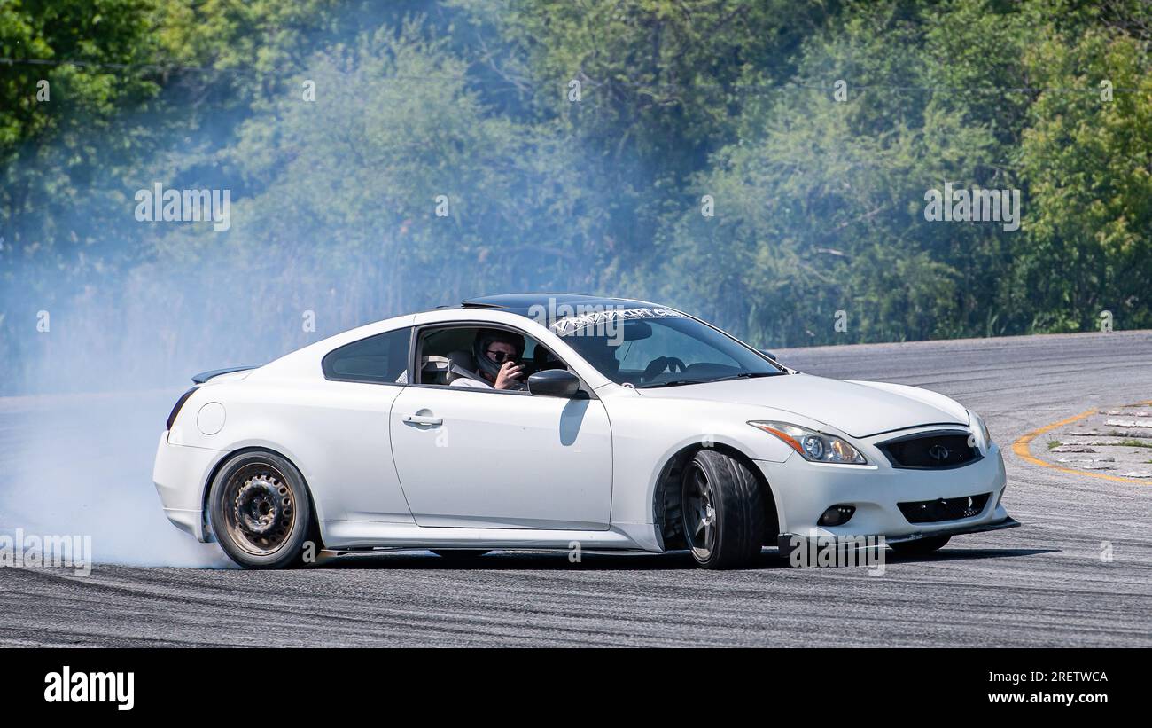 Car drifting auto racing event action with smoking tires - burning ...