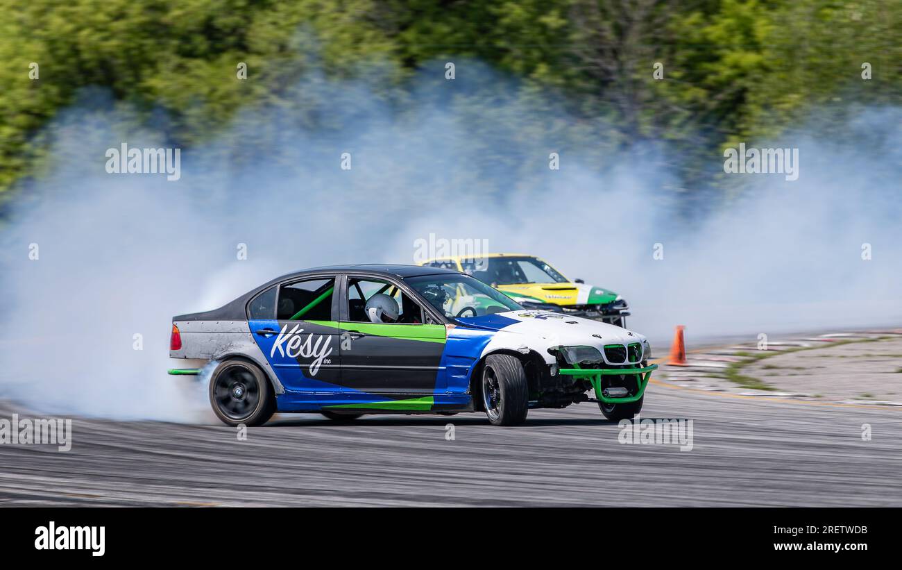 Car drifting auto racing event action with smoking tires - burning ...