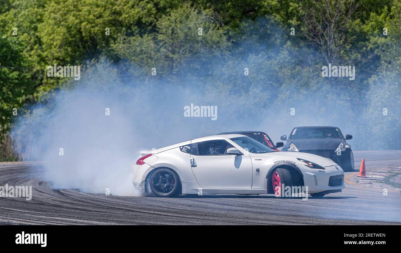 Car drifting auto racing event action with smoking tires - burning ...