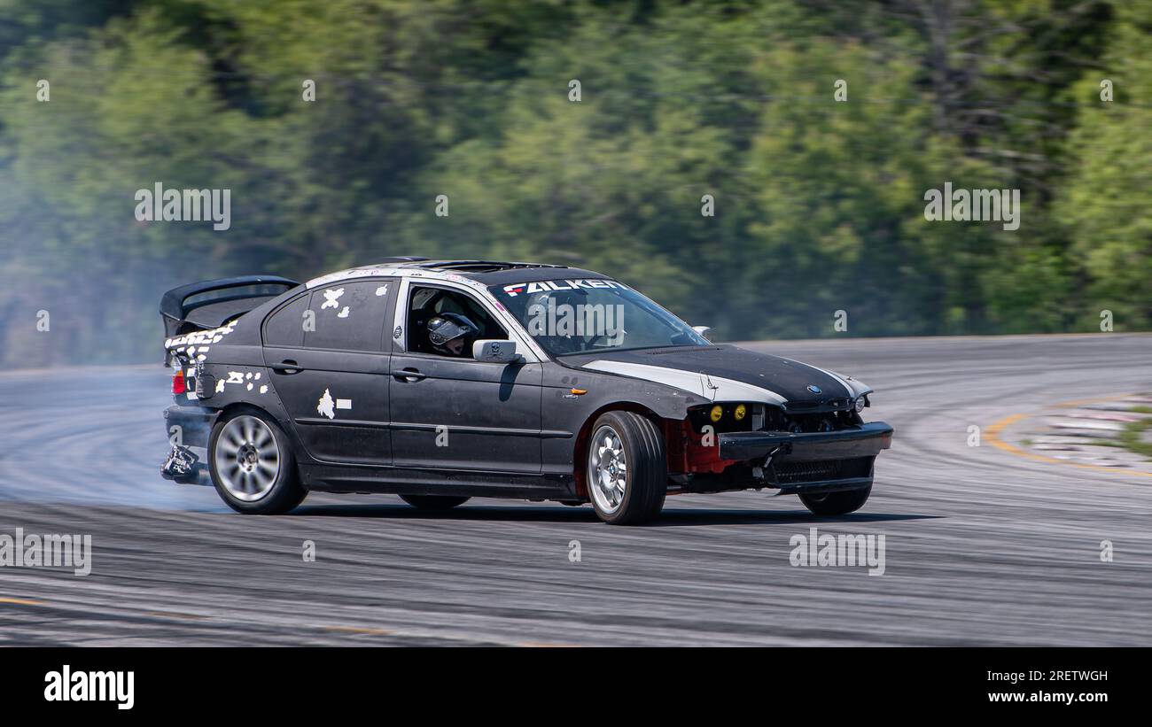 Car drifting auto racing event action with smoking tires - burning ...