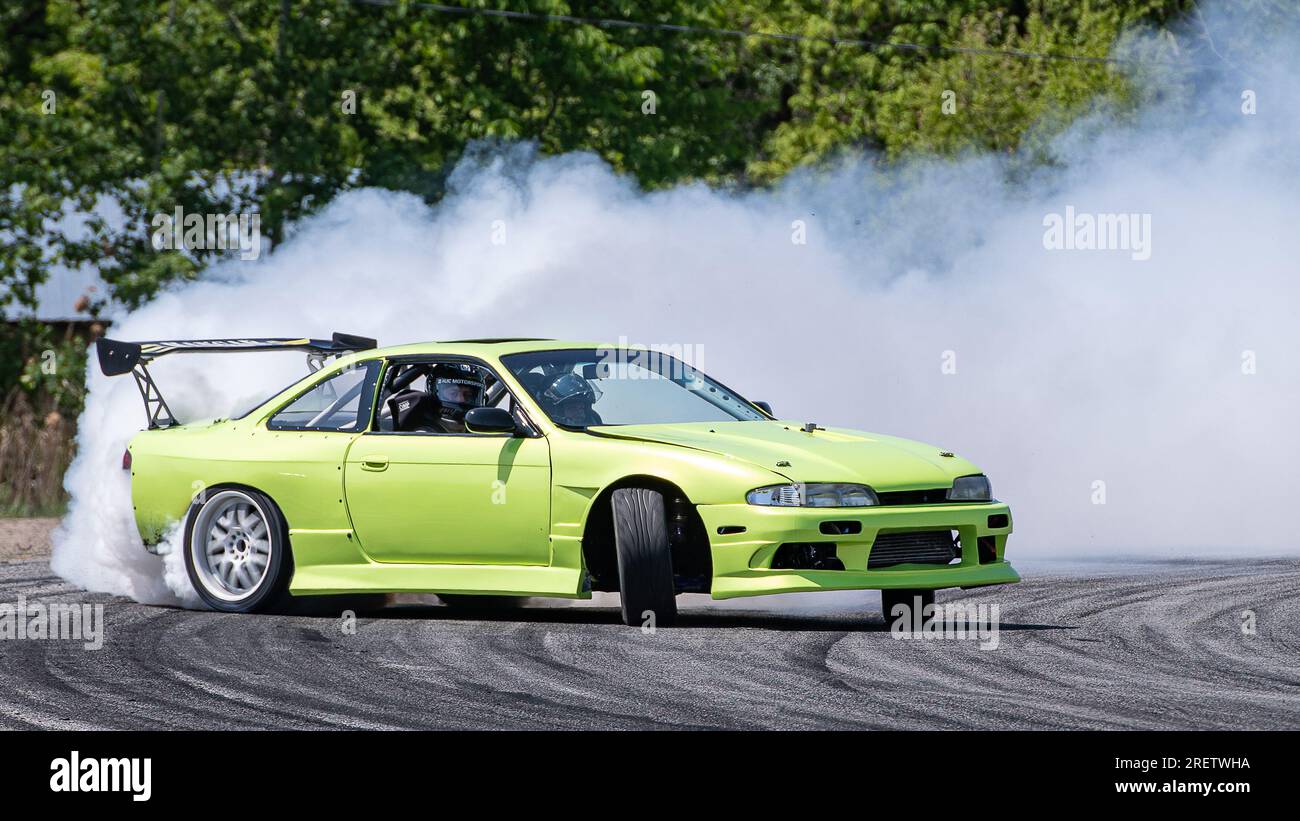 Car drifting auto racing event action with smoking tires - burning ...