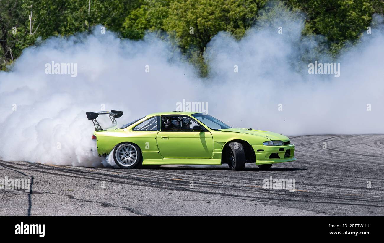 Car drifting auto racing event action with smoking tires - burning ...