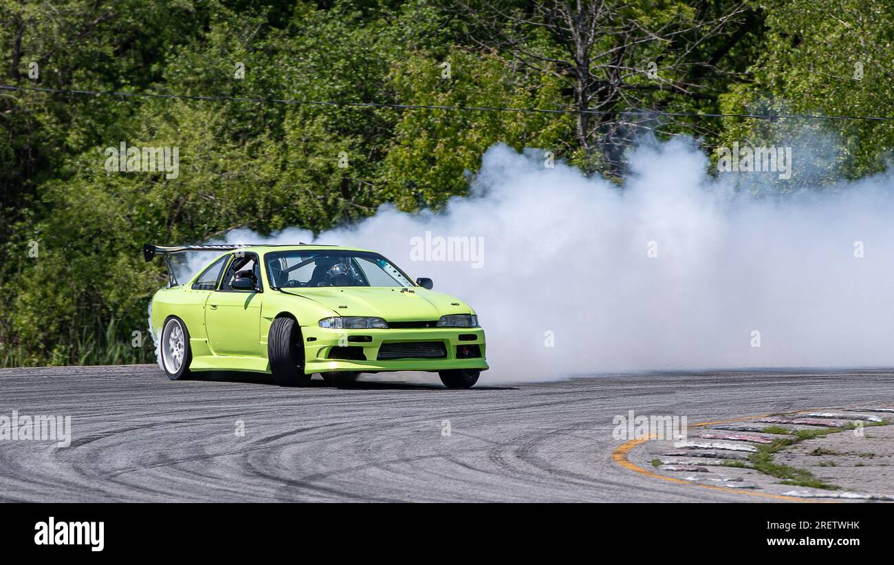 Car drifting auto racing event action with smoking tires - burning ...