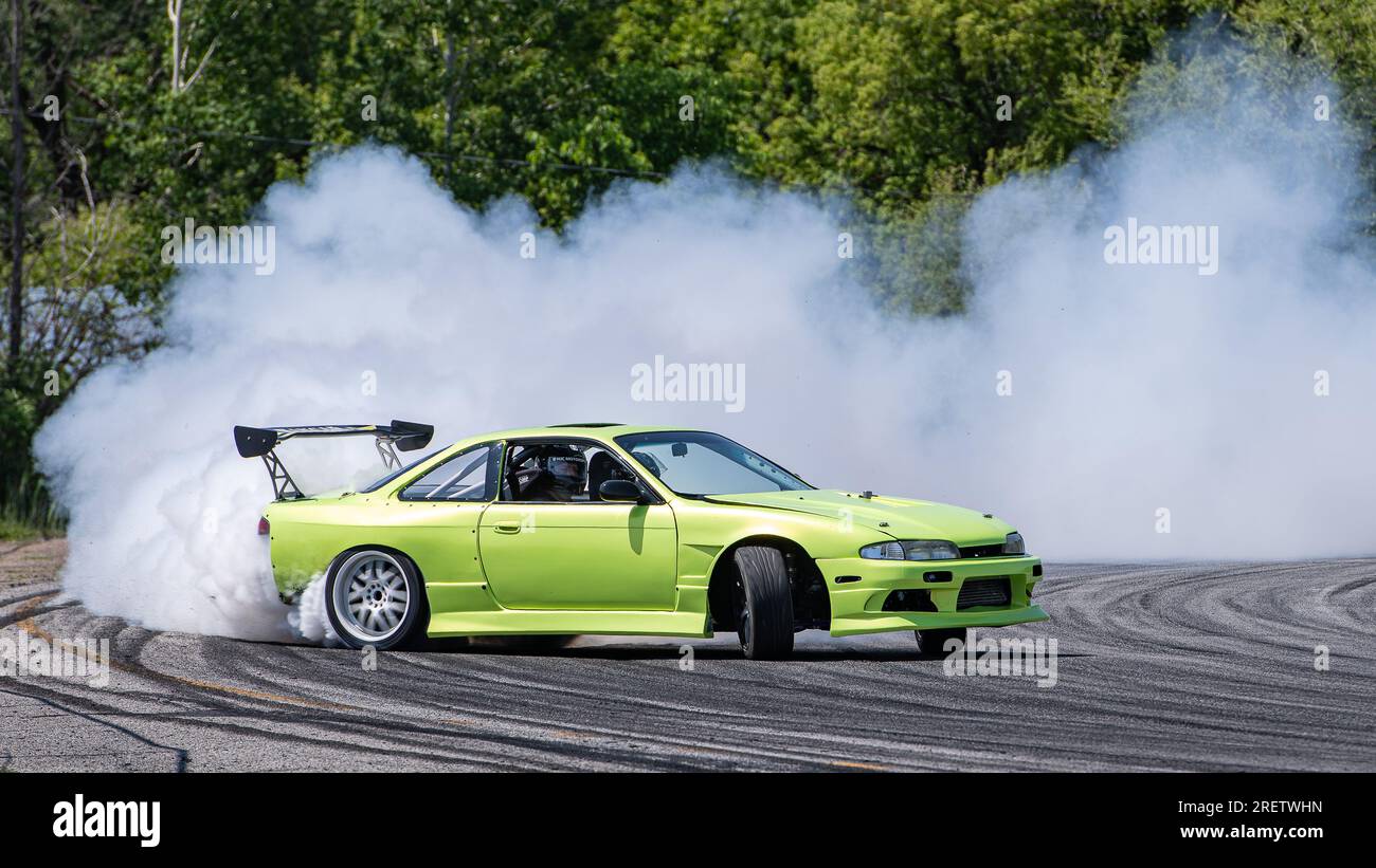 Car drifting auto racing event action with smoking tires - burning ...