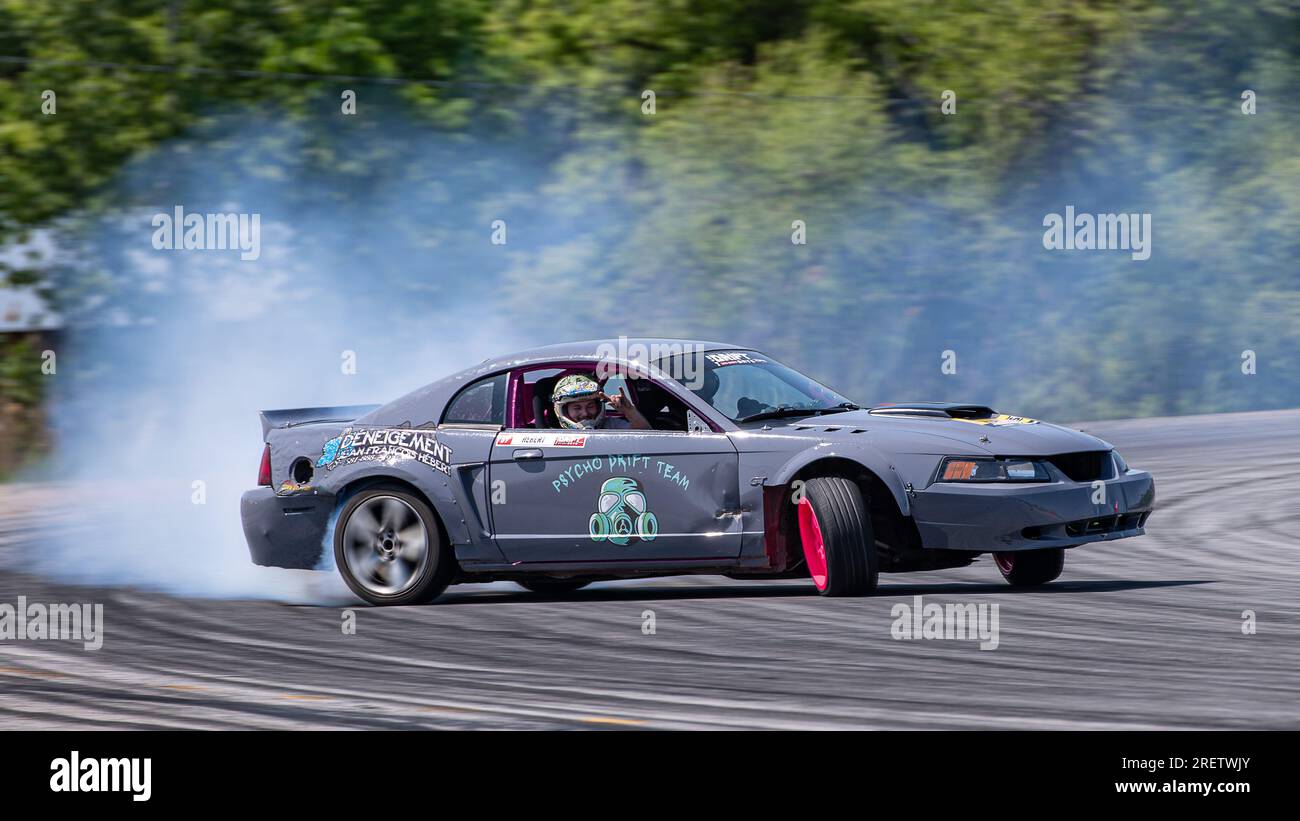 Car drifting auto racing event action with smoking tires - burning ...