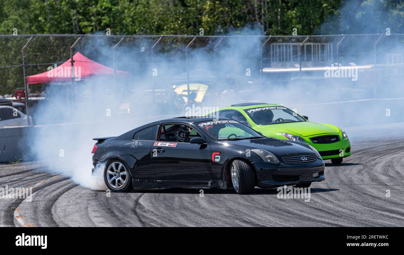 Car drifting auto racing event action with smoking tires - burning ...