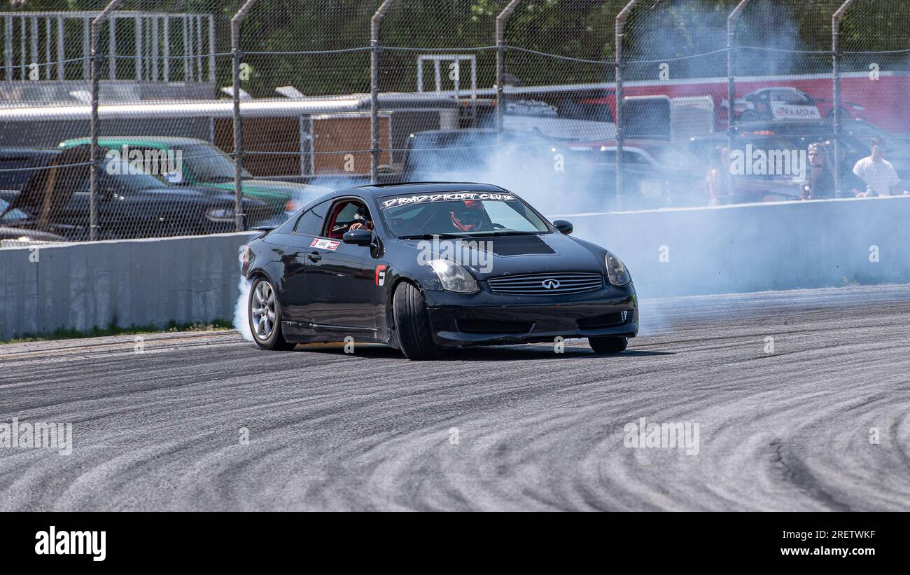 Car drifting auto racing event action with smoking tires - burning ...