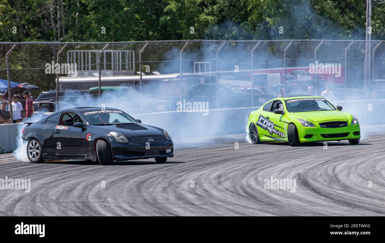 Car drifting auto racing event action with smoking tires - burning ...