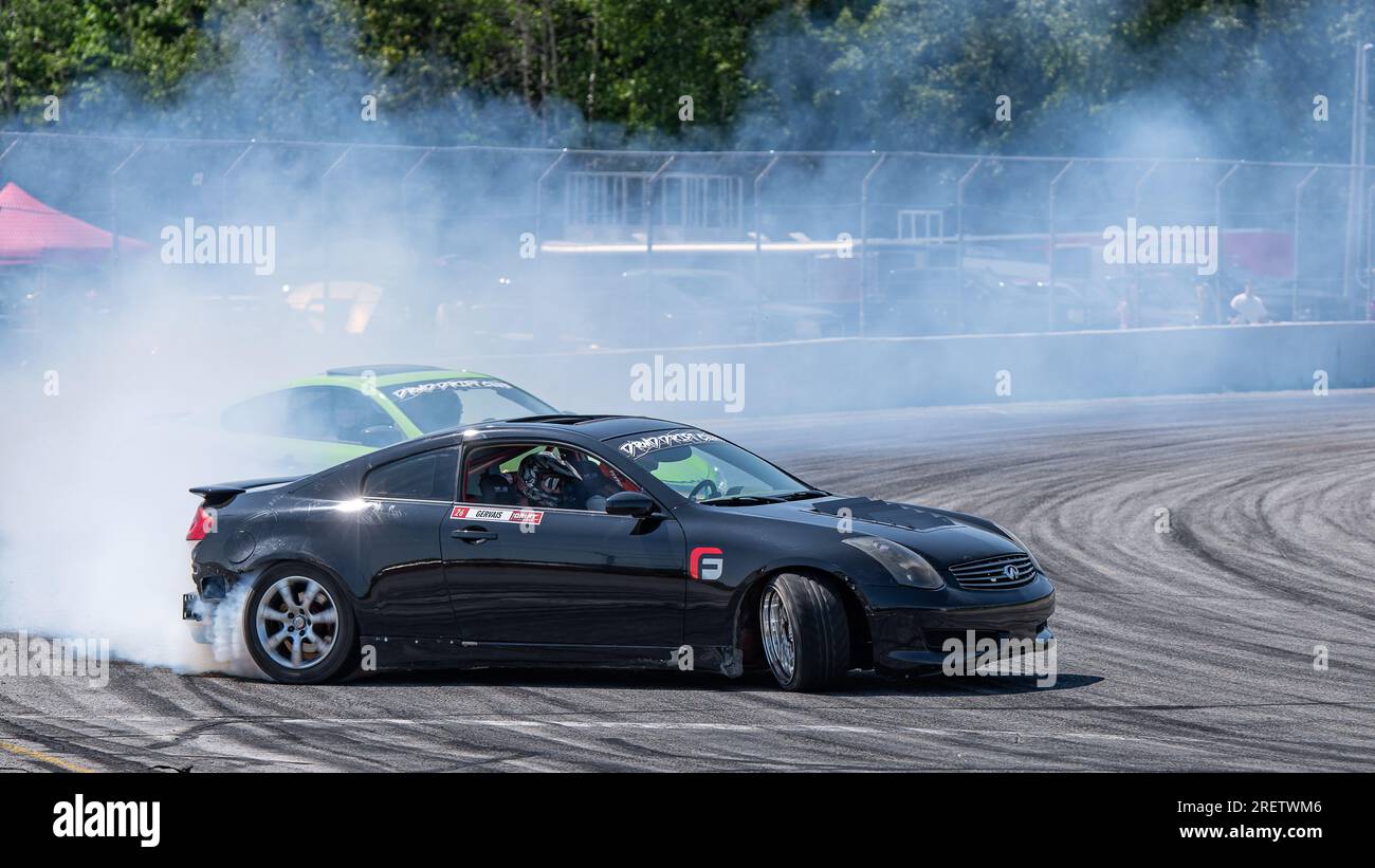 Car drifting auto racing event action with smoking tires - burning ...