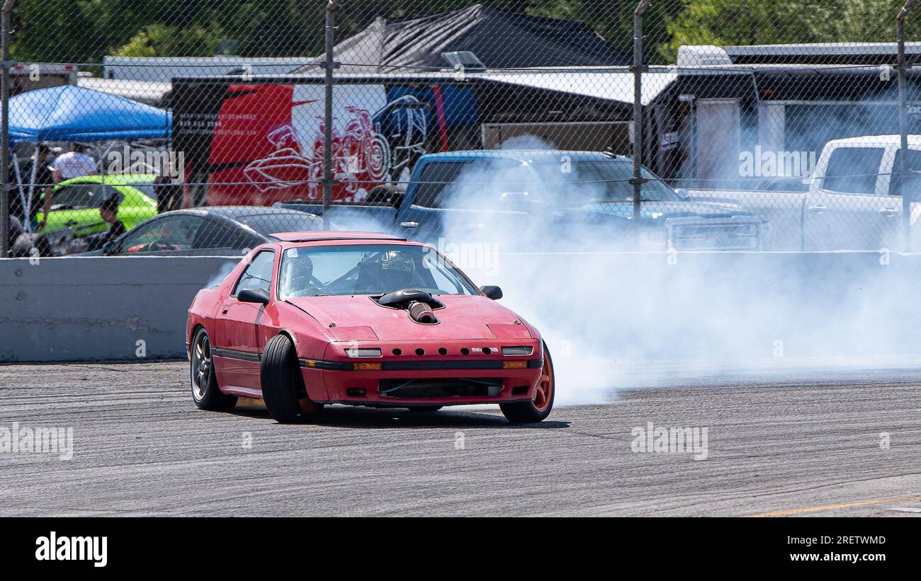 Car drifting auto racing event action with smoking tires - burning ...