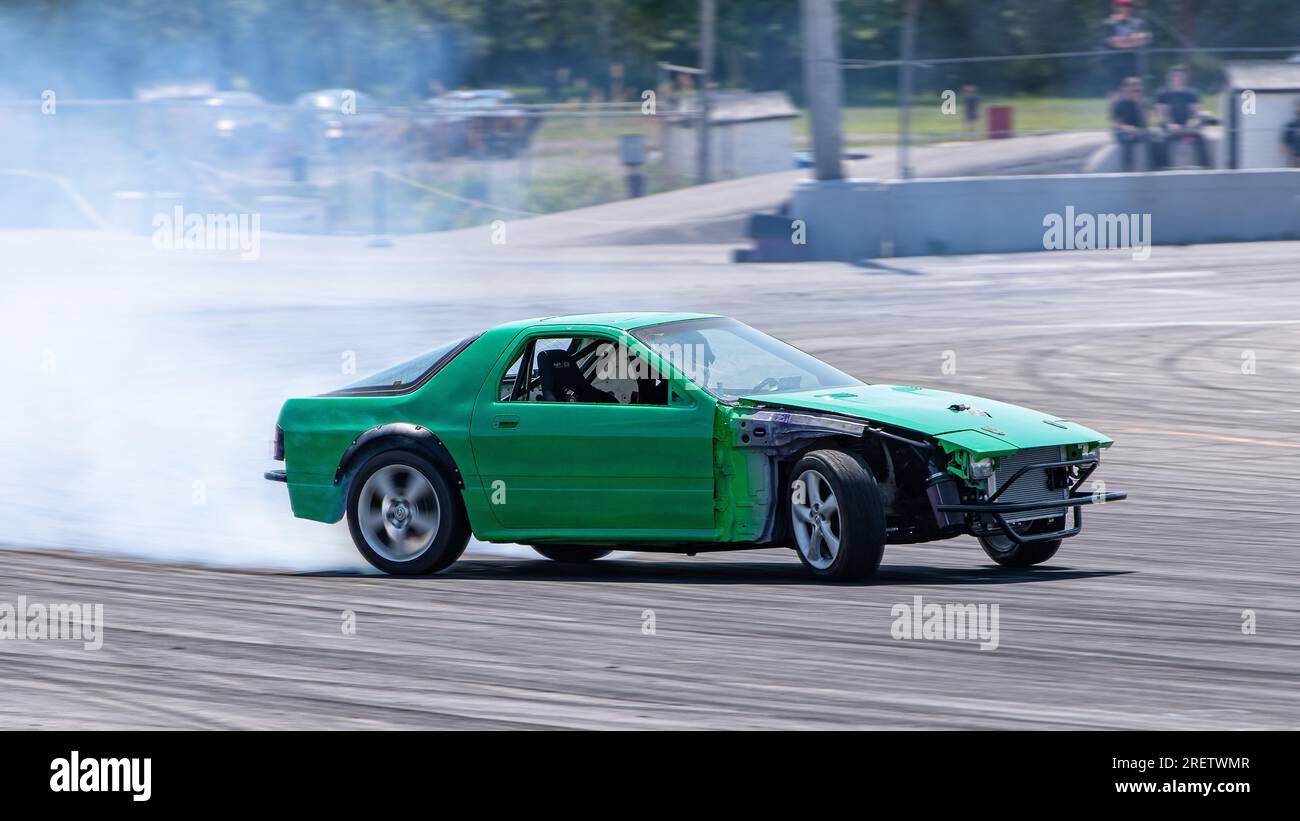 Car drifting auto racing event action with smoking tires - burning ...