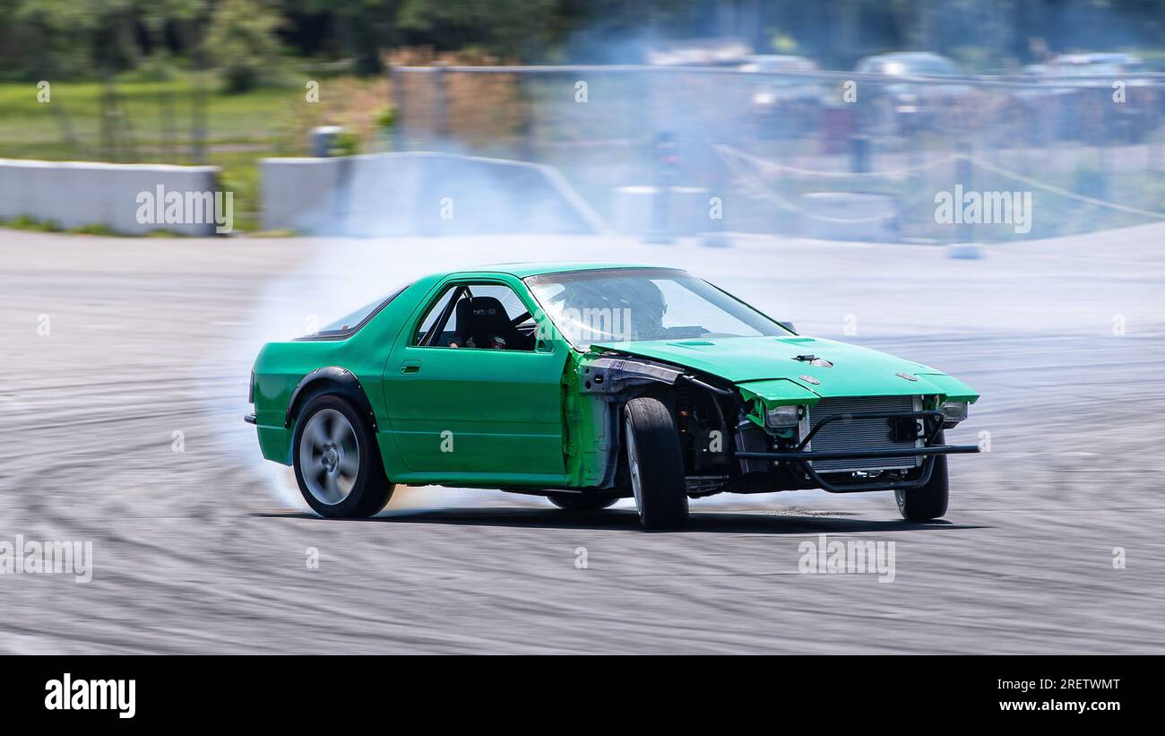Car drifting auto racing event action with smoking tires - burning ...