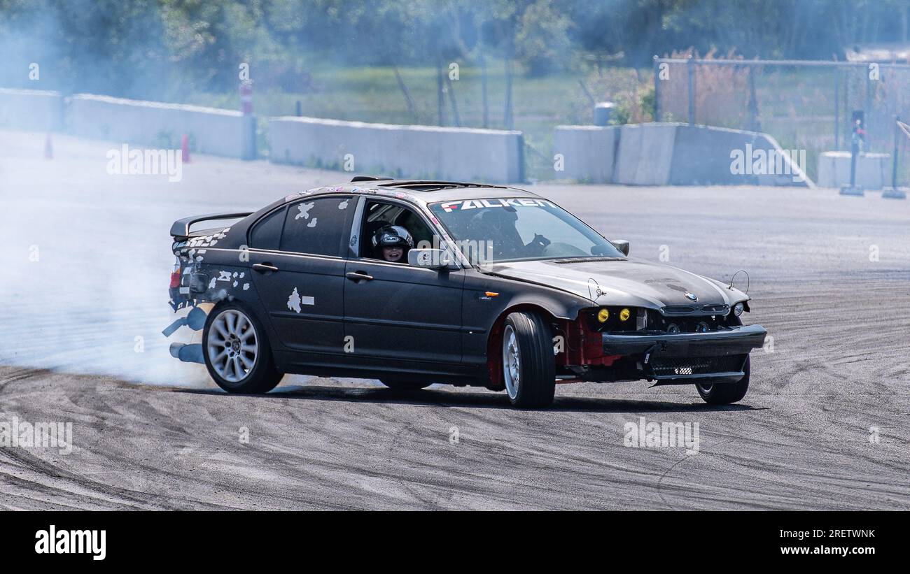 Car drifting auto racing event action with smoking tires - burning ...