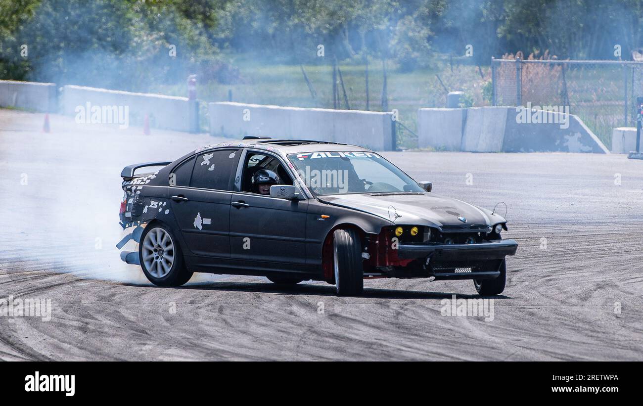 Car drifting auto racing event action with smoking tires - burning ...