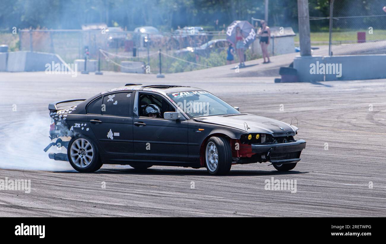 Car drifting auto racing event action with smoking tires - burning ...