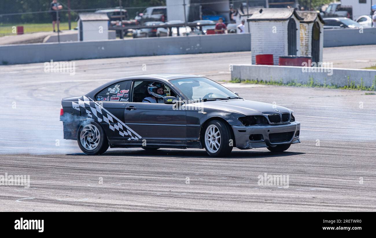 Car drifting auto racing event action with smoking tires - burning ...