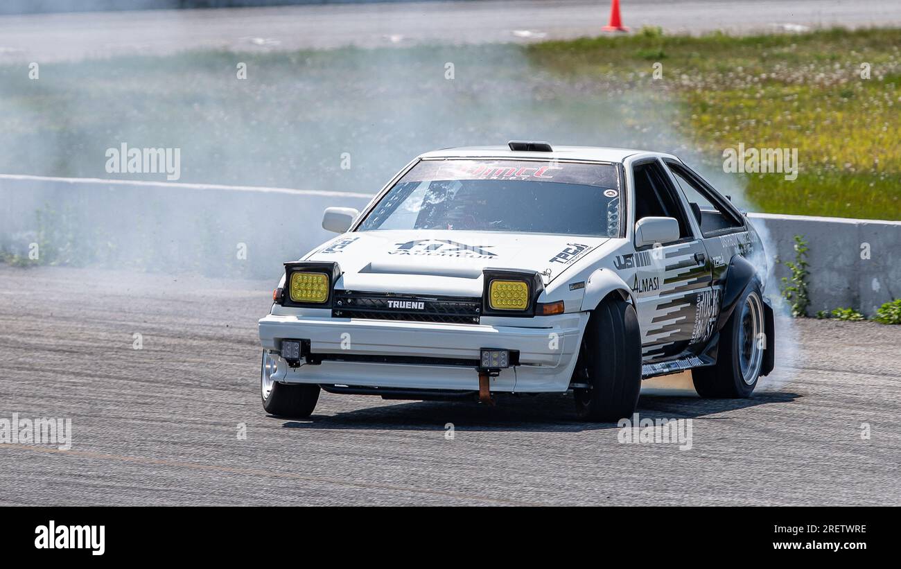 Car drifting auto racing event action with smoking tires - burning ...