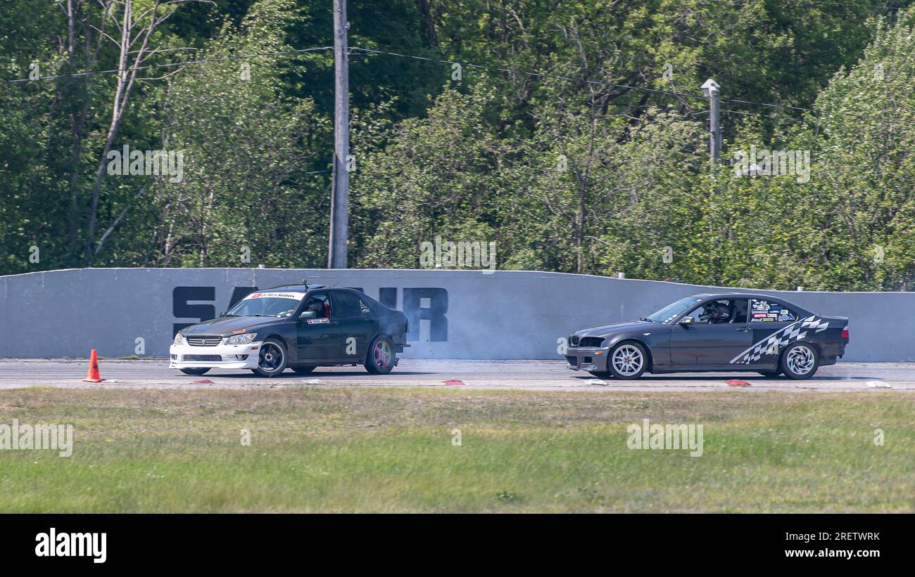 Car drifting auto racing event action with smoking tires - burning ...