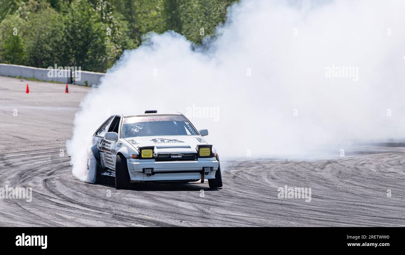 Car drifting auto racing event action with smoking tires - burning ...