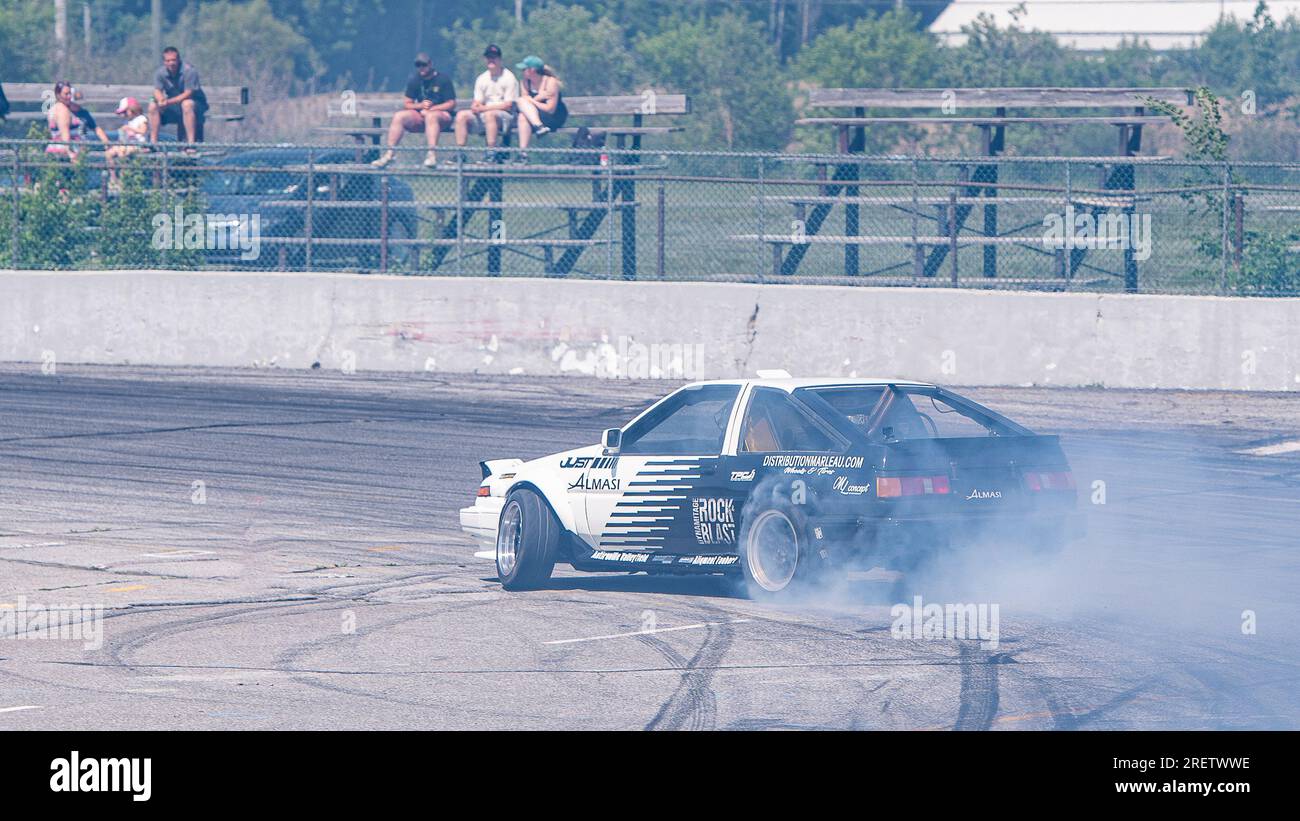 Car drifting auto racing event action with smoking tires - burning ...