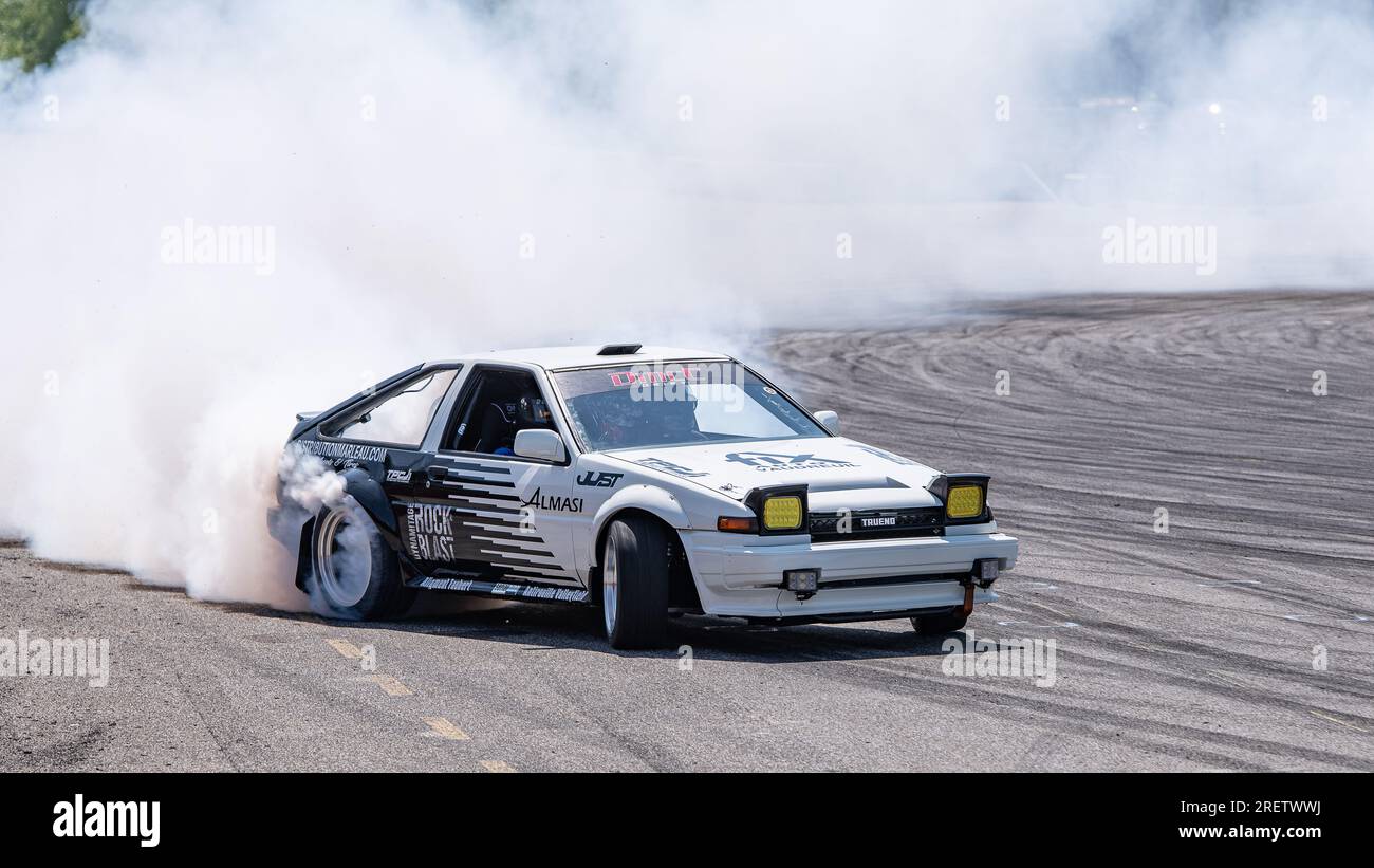 Car drifting auto racing event action with smoking tires - burning ...