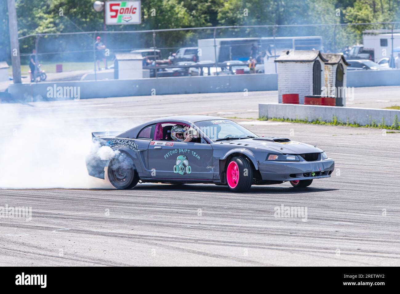Car drifting auto racing event action with smoking tires - burning ...
