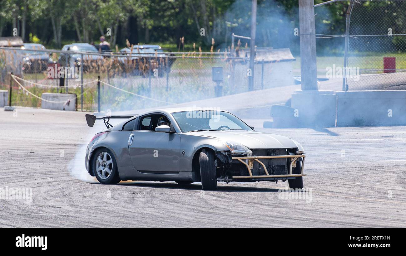 Car drifting auto racing event action with smoking tires - burning ...
