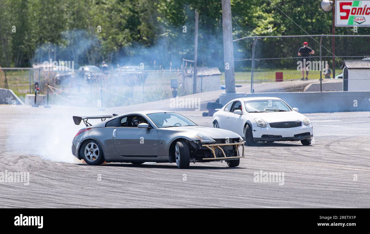 Car drifting auto racing event action with smoking tires - burning ...
