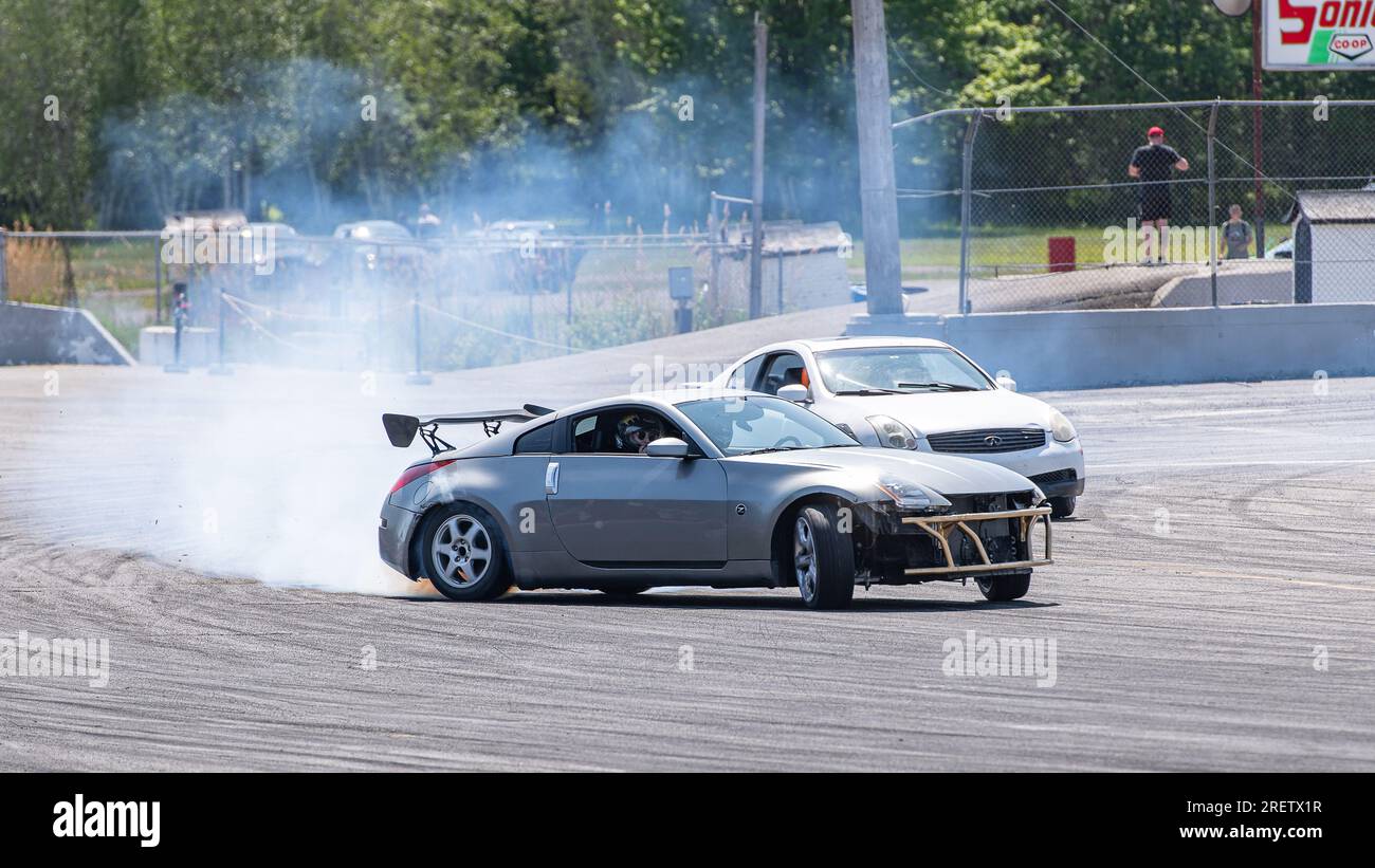 Car drifting auto racing event action with smoking tires - burning ...