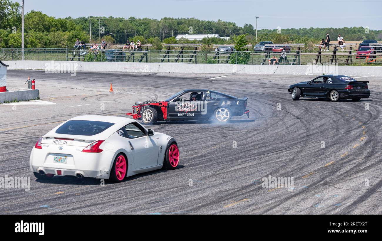 Car drifting auto racing event action with smoking tires - burning ...