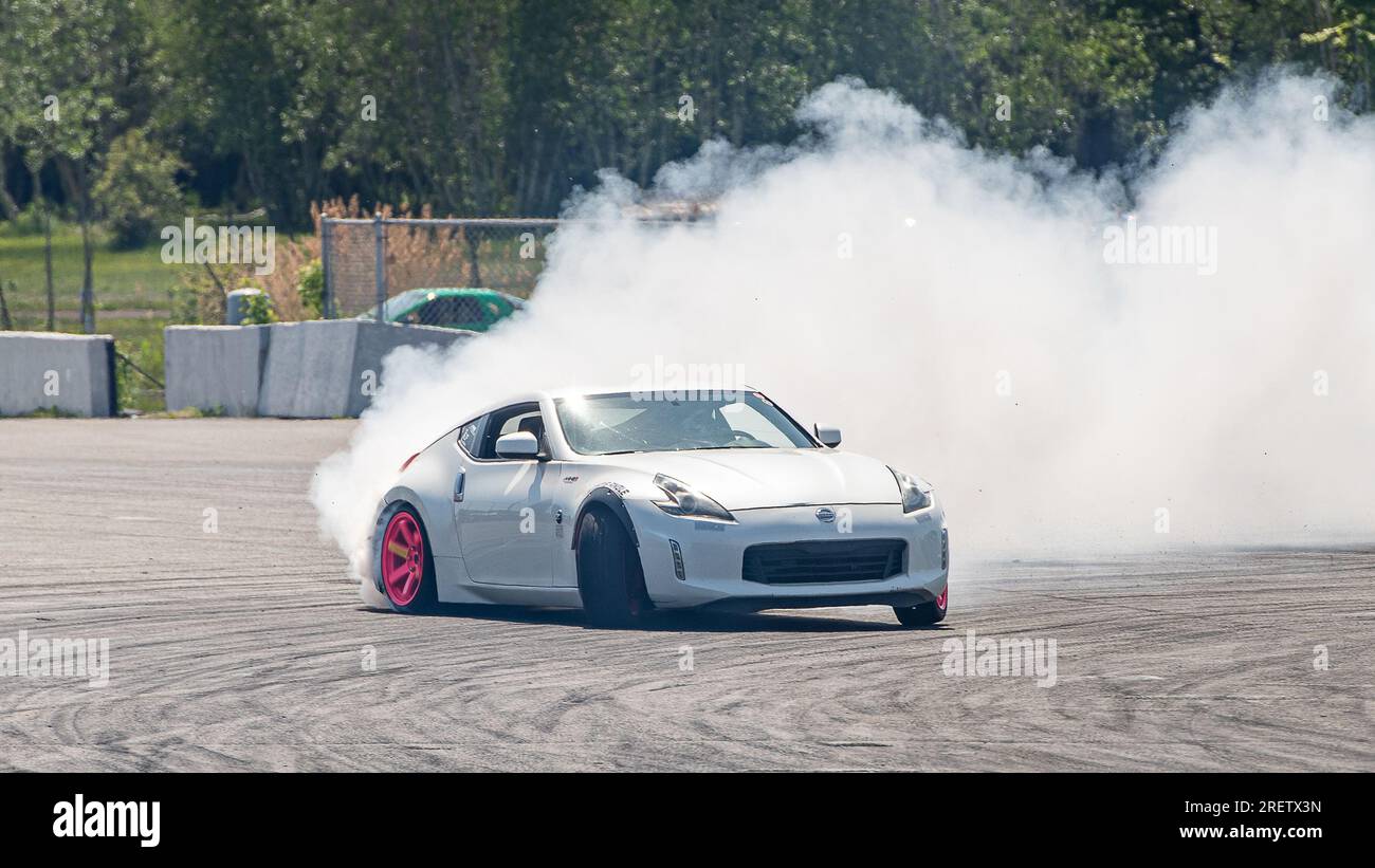 Car drifting auto racing event action with smoking tires - burning ...
