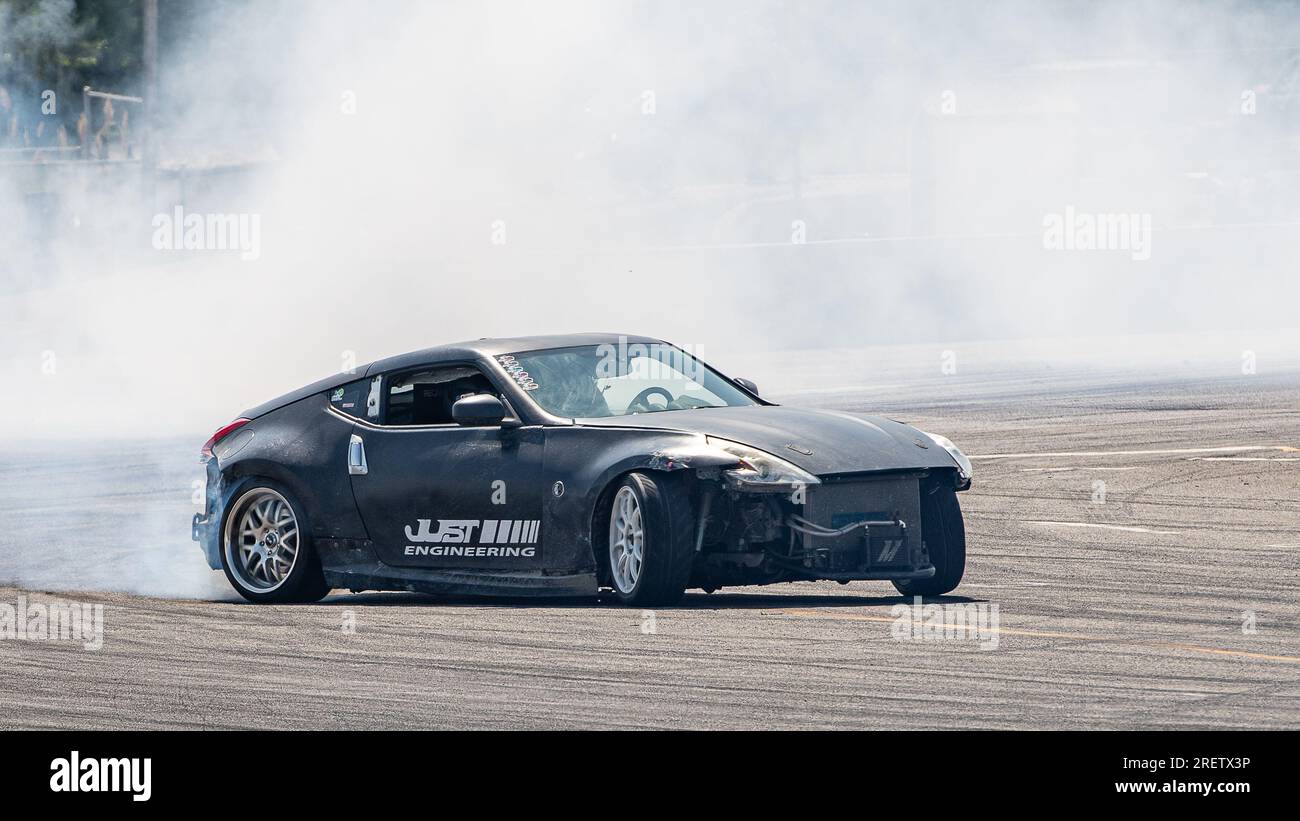 Car drifting auto racing event action with smoking tires - burning ...