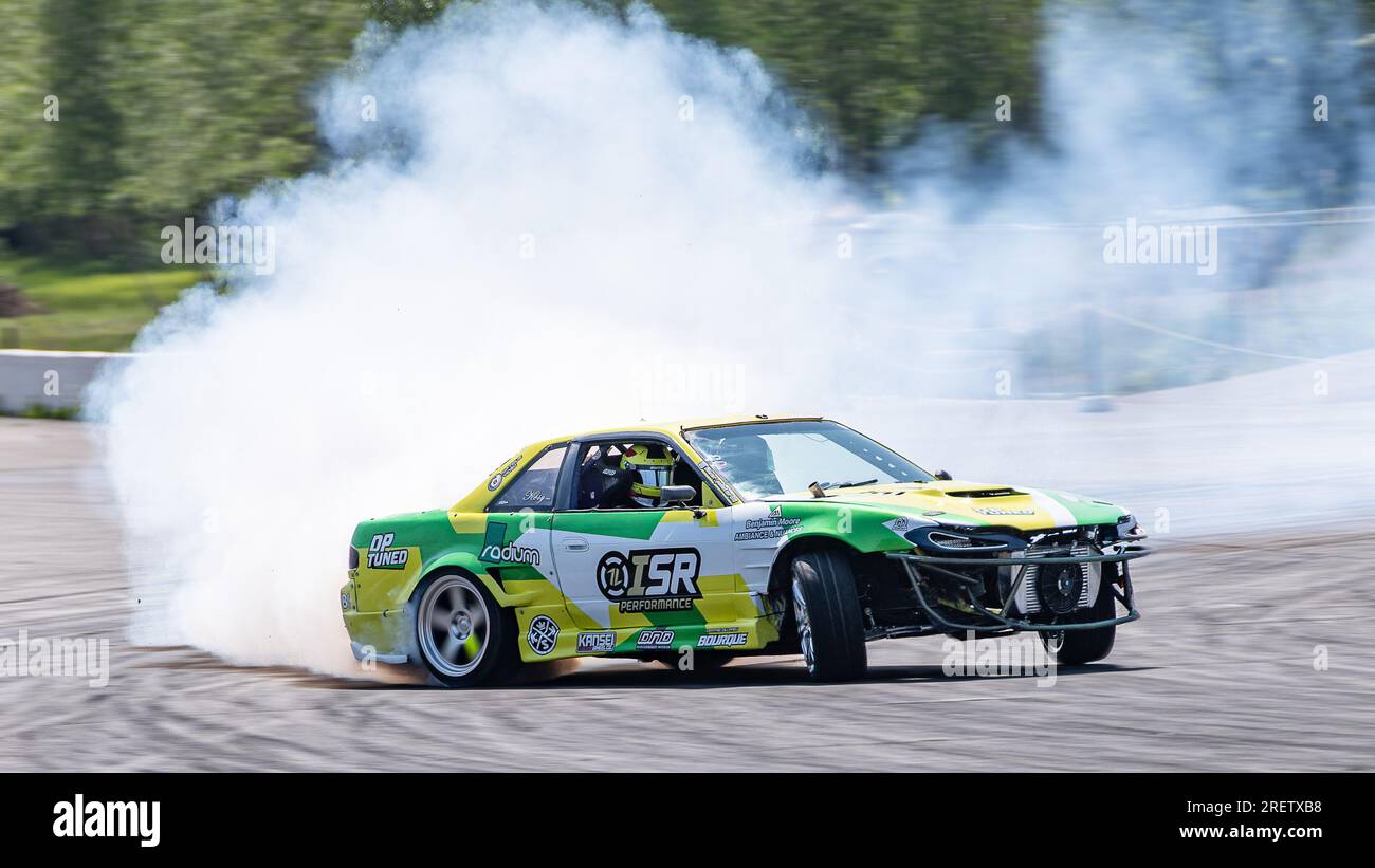 Car drifting auto racing event action with smoking tires - burning ...