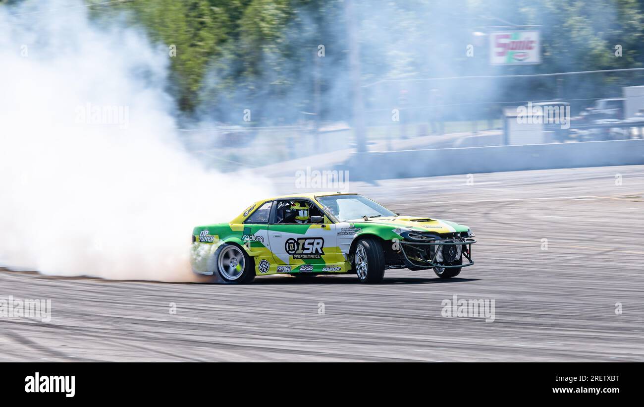 Car drifting auto racing event action with smoking tires - burning ...