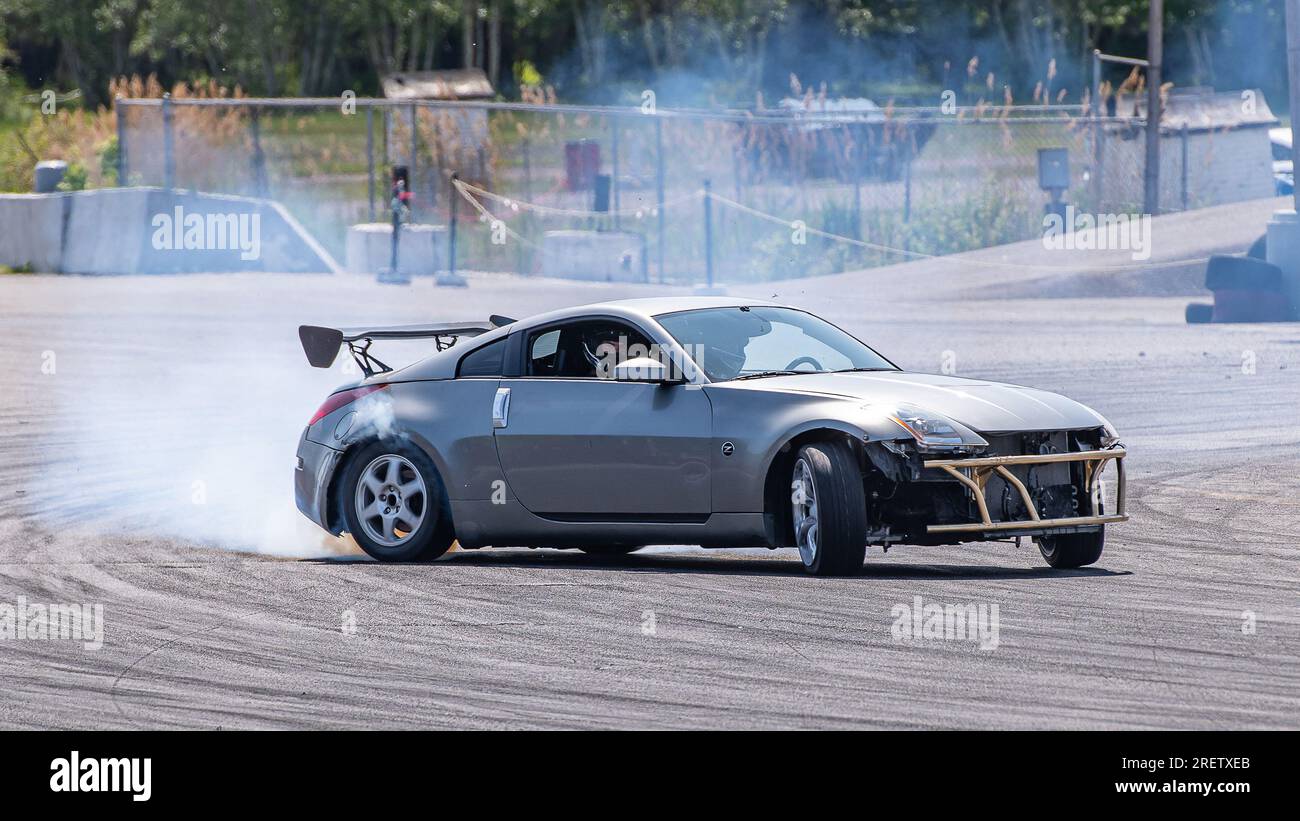 Car drifting auto racing event action with smoking tires - burning ...