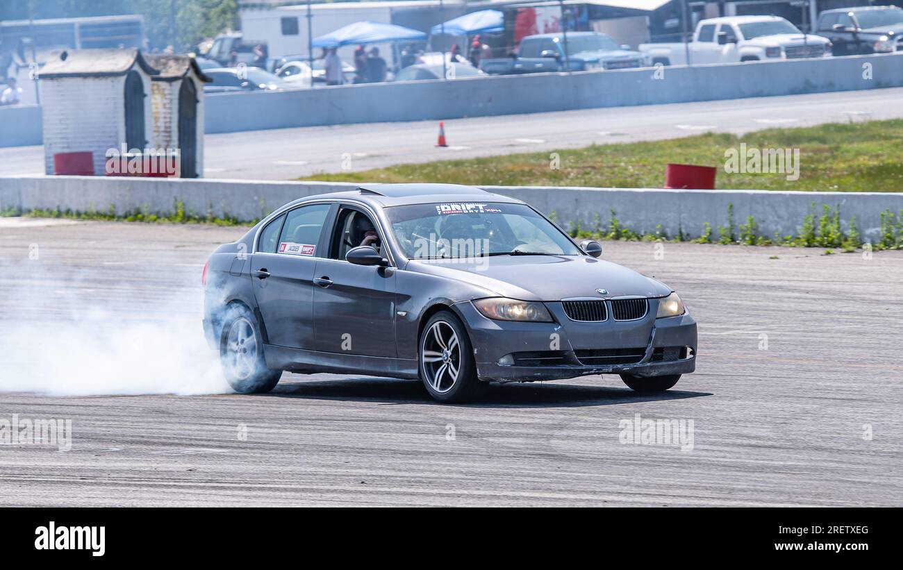 Car drifting auto racing event action with smoking tires - burning ...