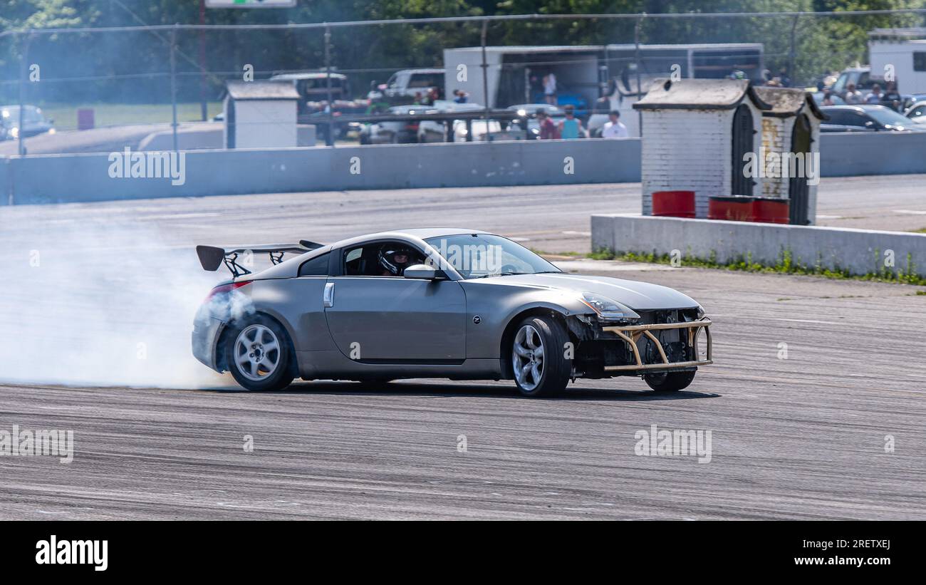 Car drifting auto racing event action with smoking tires - burning ...