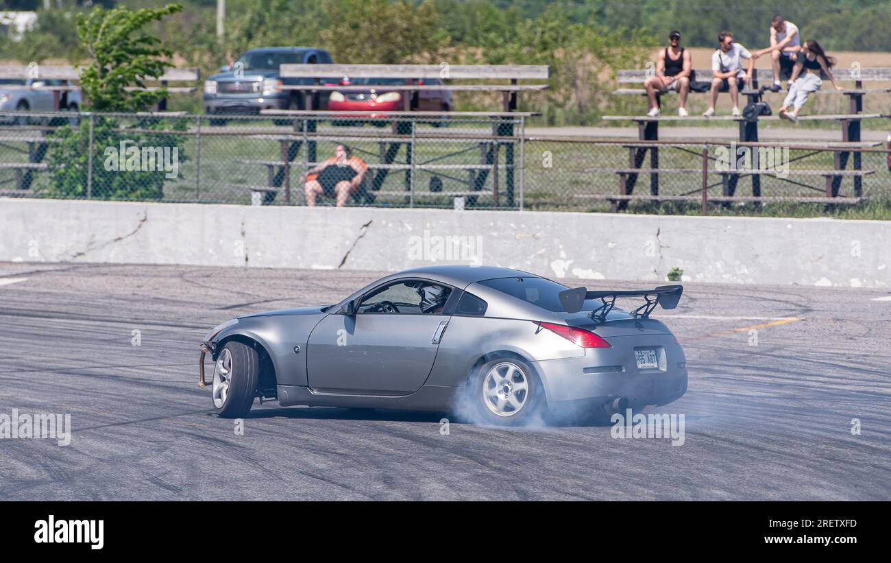 Car drifting auto racing event action with smoking tires - burning ...