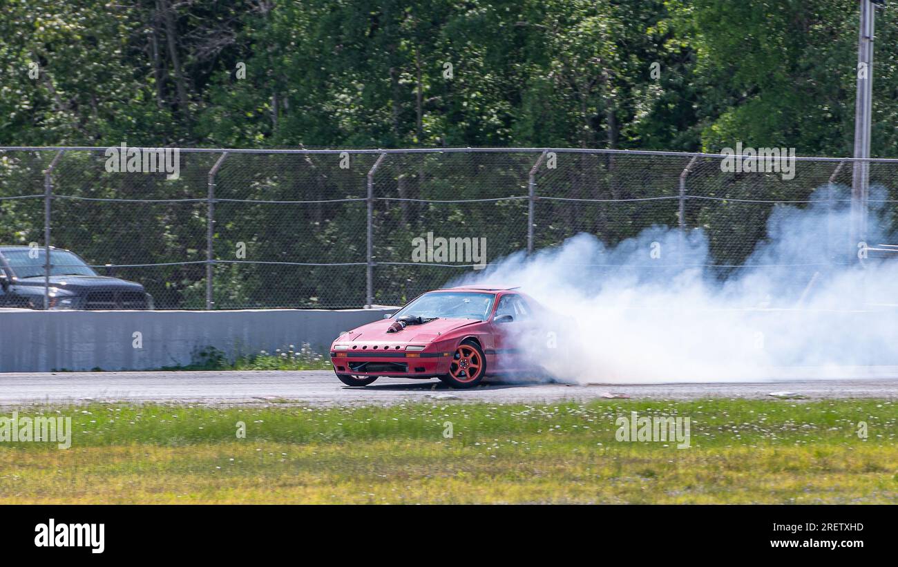 Car drifting auto racing event action with smoking tires - burning ...