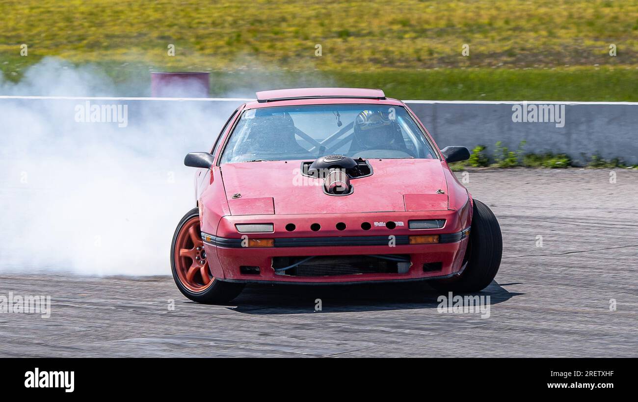 Car drifting auto racing event action with smoking tires - burning ...