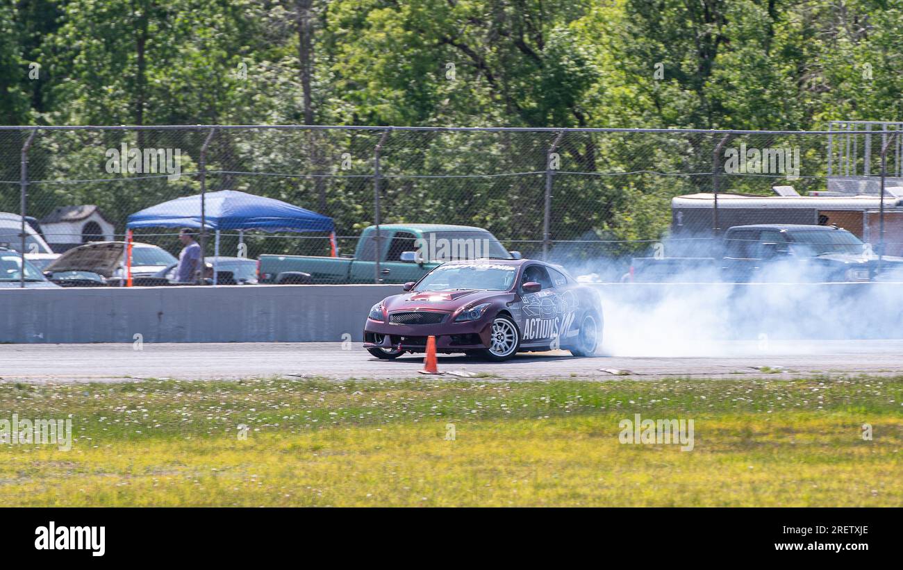 Car drifting auto racing event action with smoking tires - burning ...