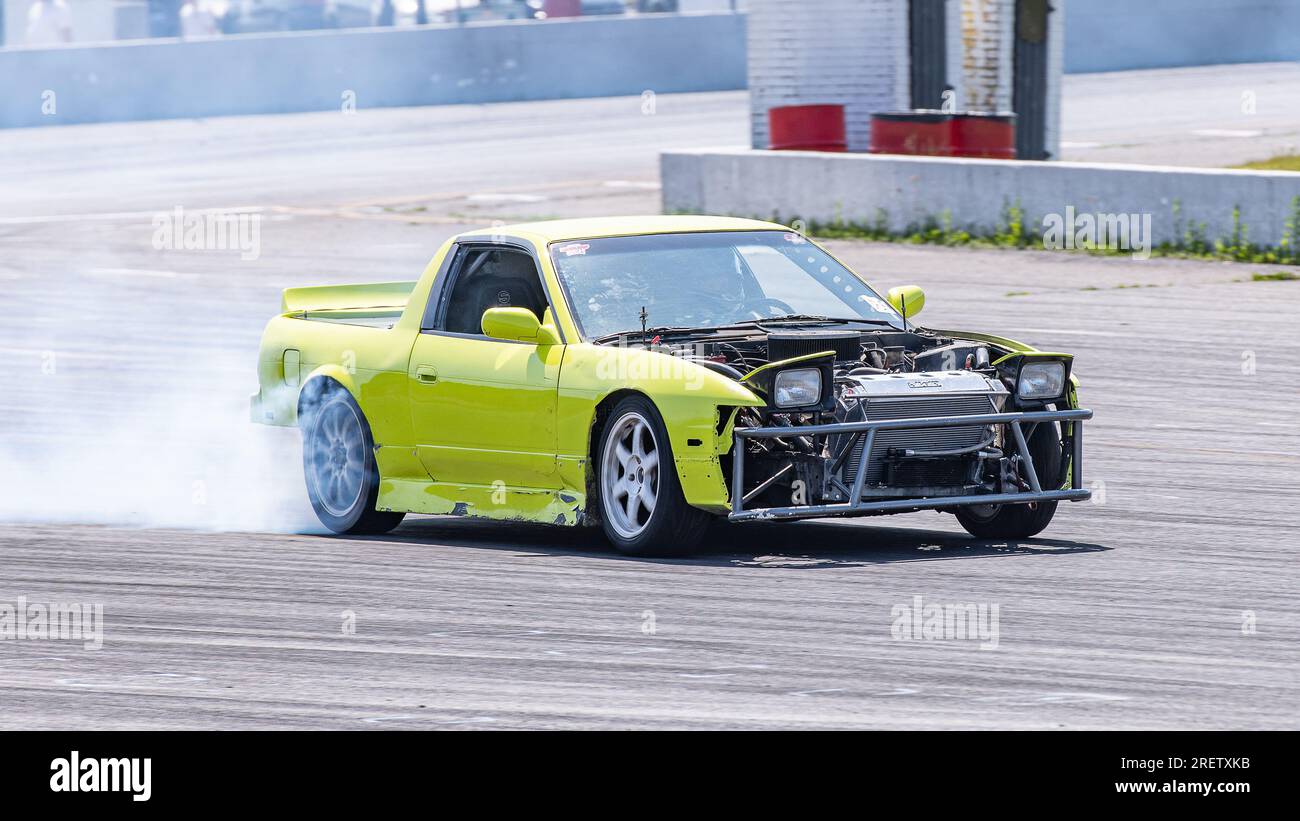 Car drifting auto racing event action with smoking tires - burning ...
