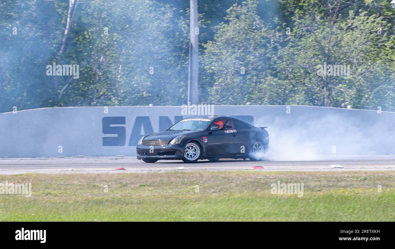 Car drifting auto racing event action with smoking tires - burning ...