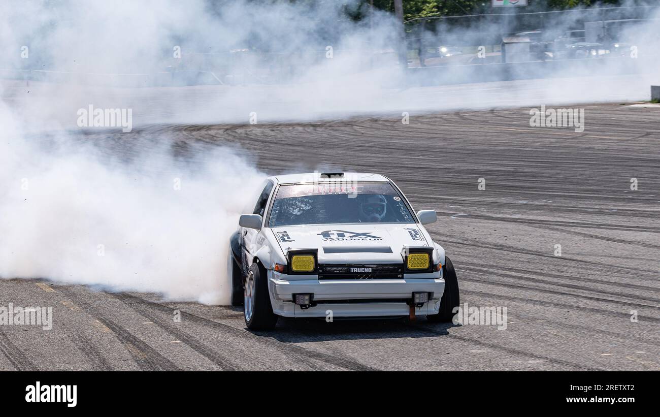 Car drifting auto racing event action with smoking tires - burning ...