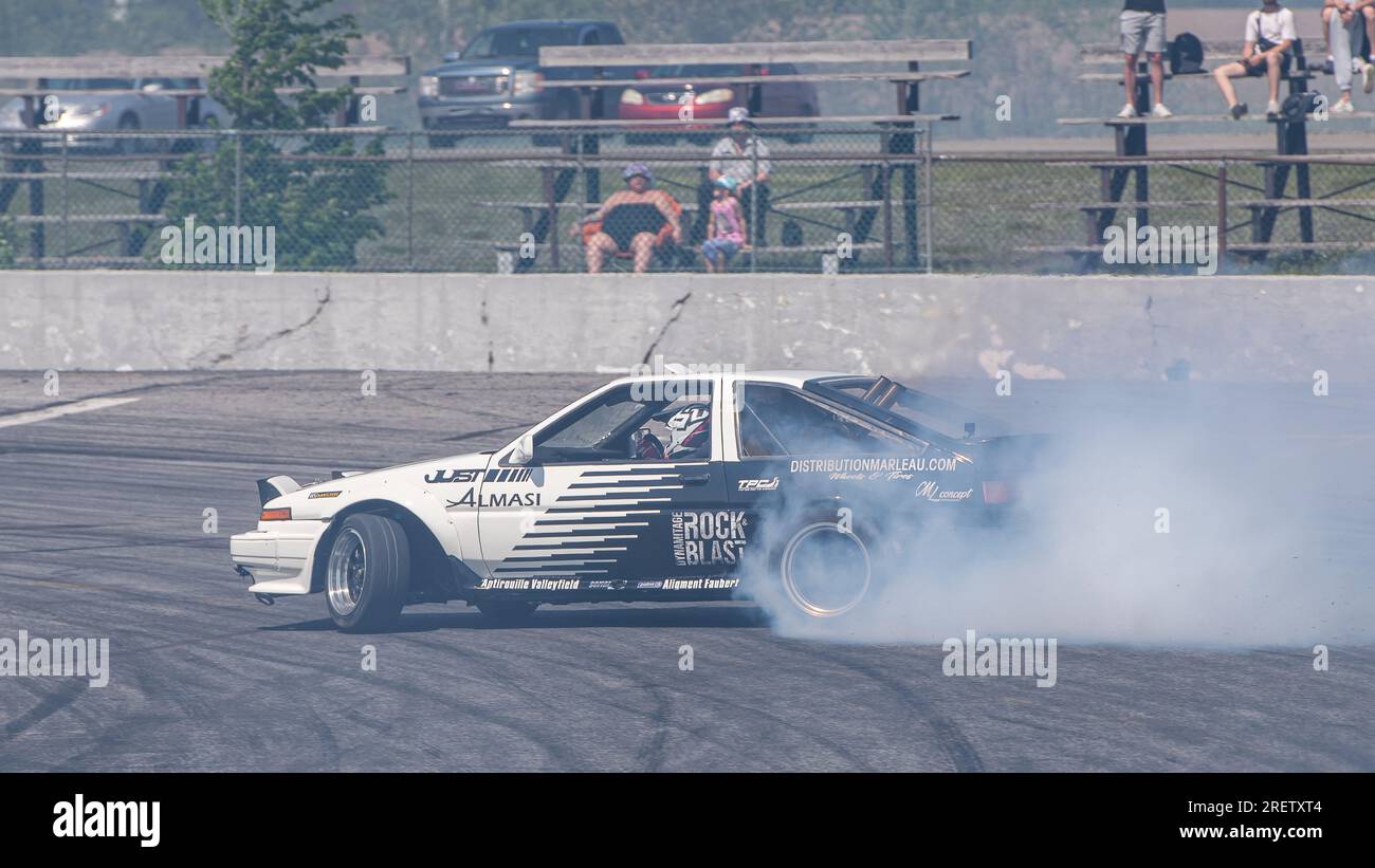Car drifting auto racing event action with smoking tires - burning ...