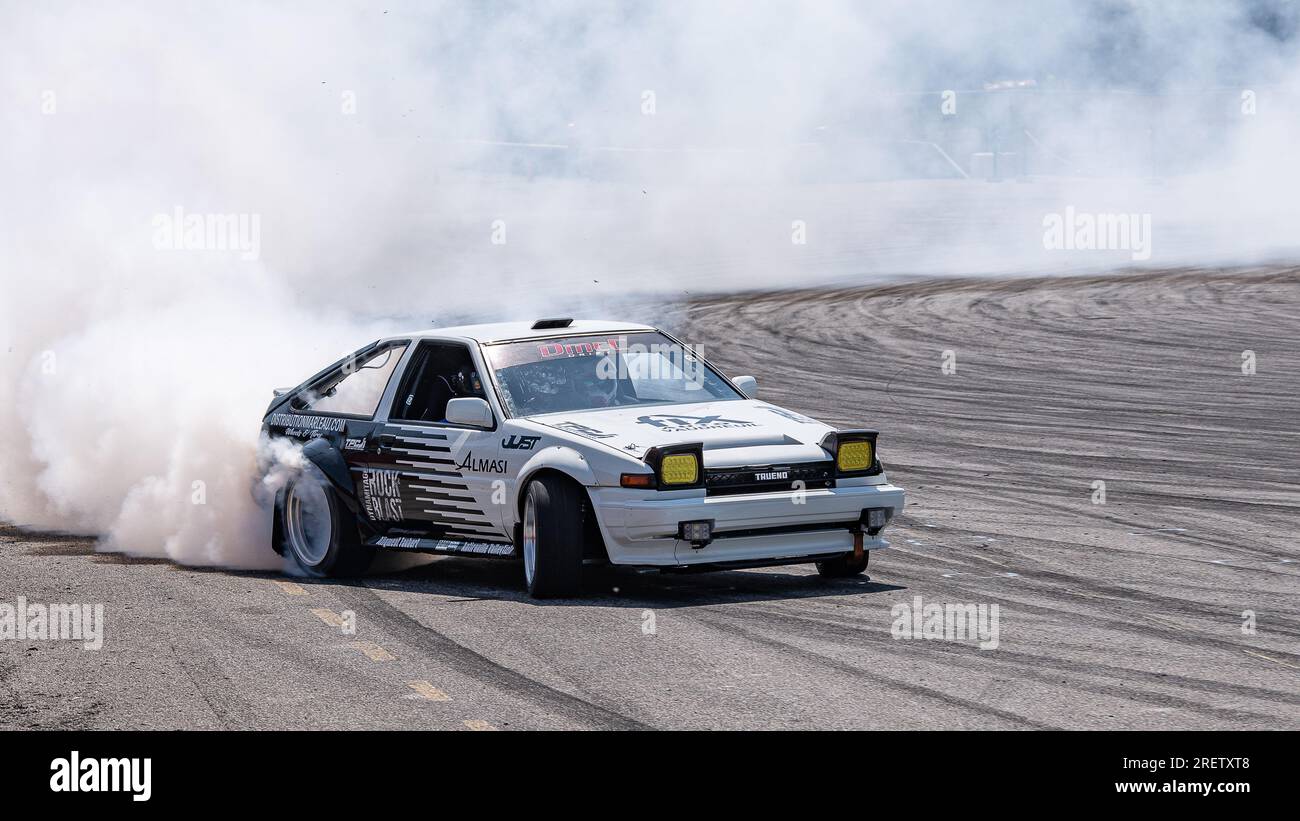Car drifting auto racing event action with smoking tires - burning ...