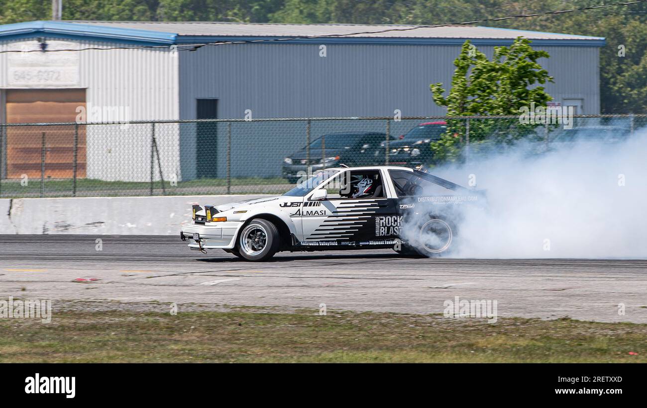 Car drifting auto racing event action with smoking tires - burning ...
