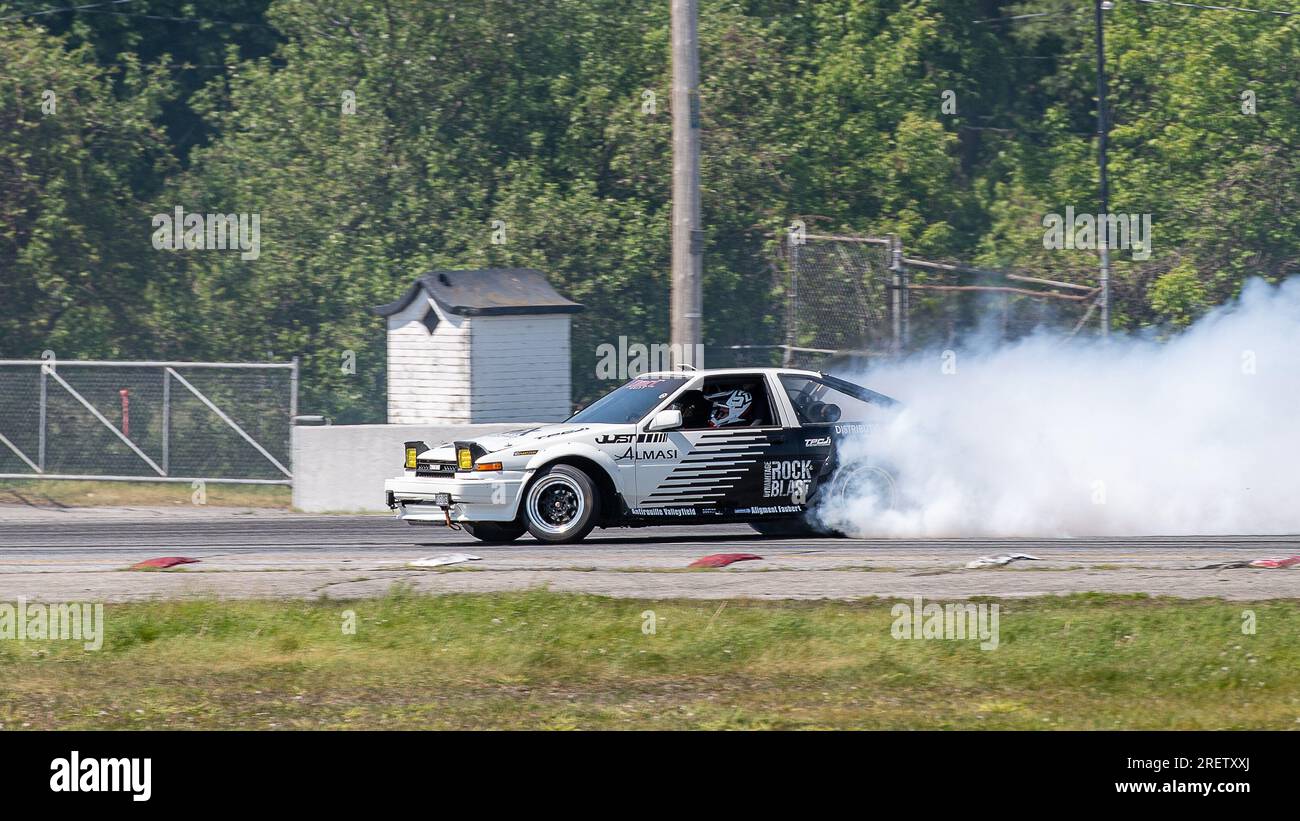 Car drifting auto racing event action with smoking tires - burning ...