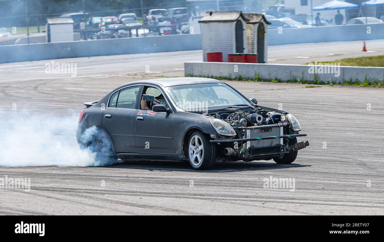Car drifting auto racing event action with smoking tires - burning ...